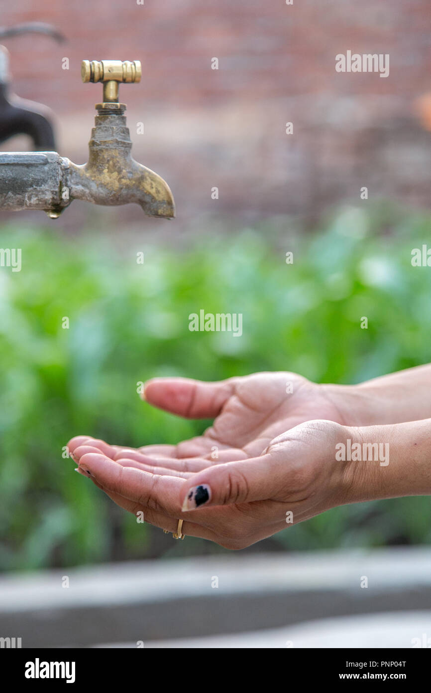 Women holds hand under a water tap and waiting for water Stock Photo ...