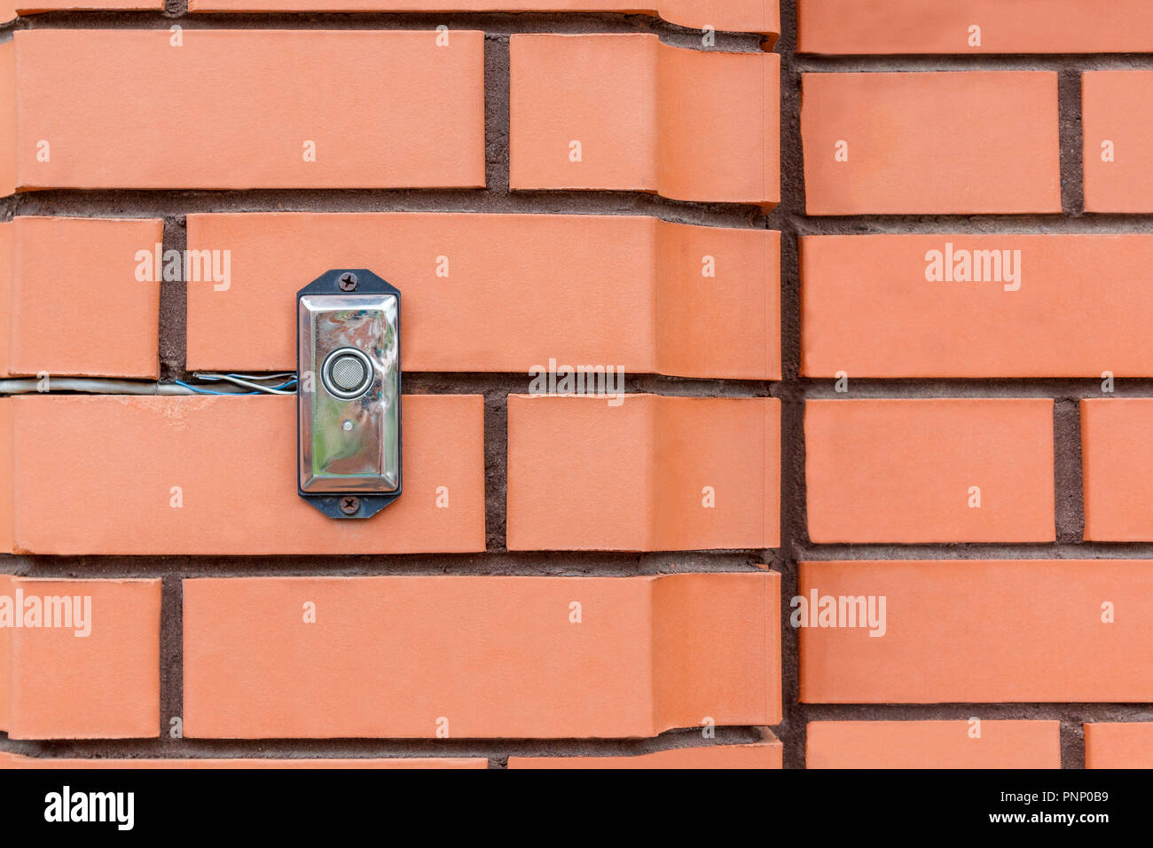 Metallic electric doorbell on a red brick wall with copy space Stock ...