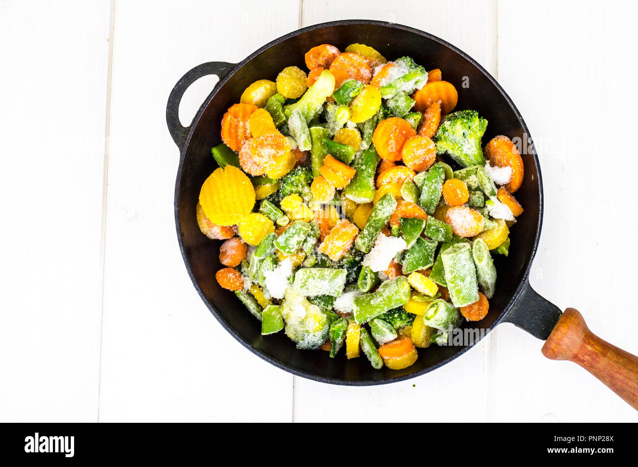 Frying pan with frozen vegetables. Studio Photo Stock Photo - Alamy