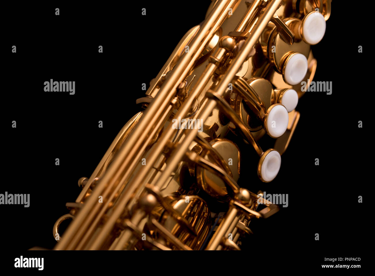 Gold lacquered saxophone with pearl keys on black background Stock ...