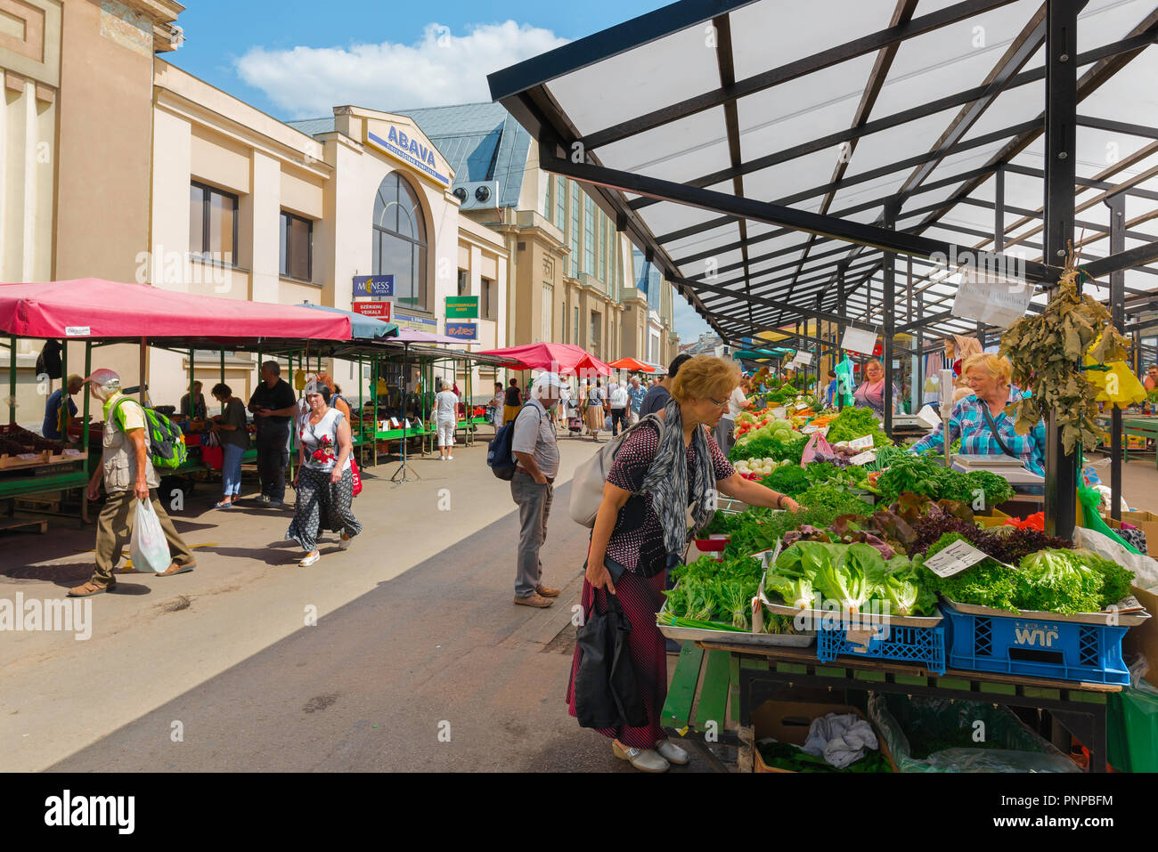 Riga Market, view of a Latvian woman buying vegetables at a stall ...