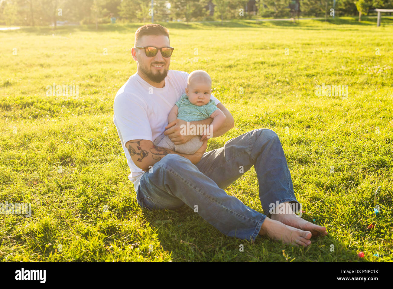 Happy father holding baby son on nature. Concept of happy family ...