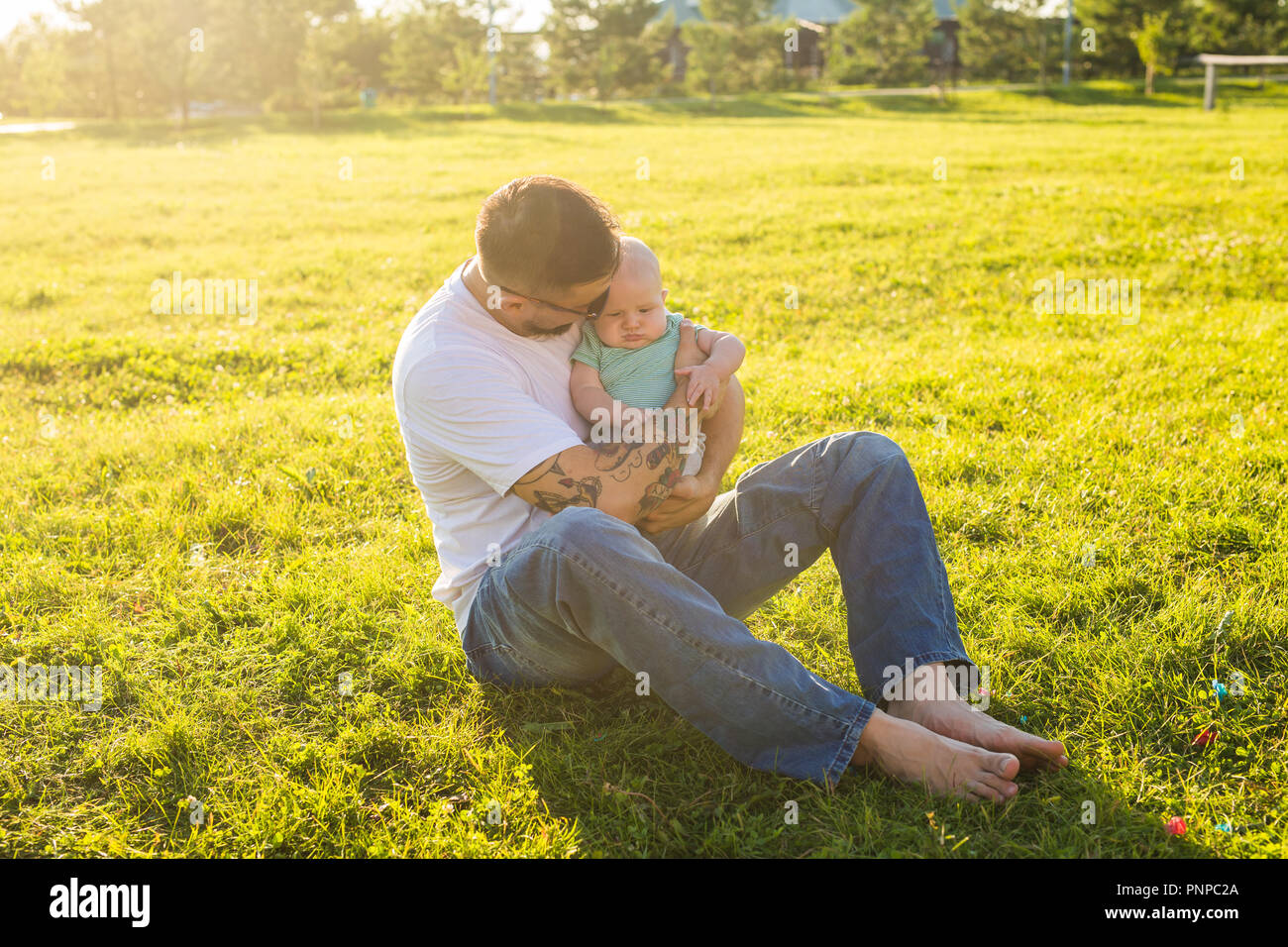 Happy father holding baby son on nature. Concept of happy family ...
