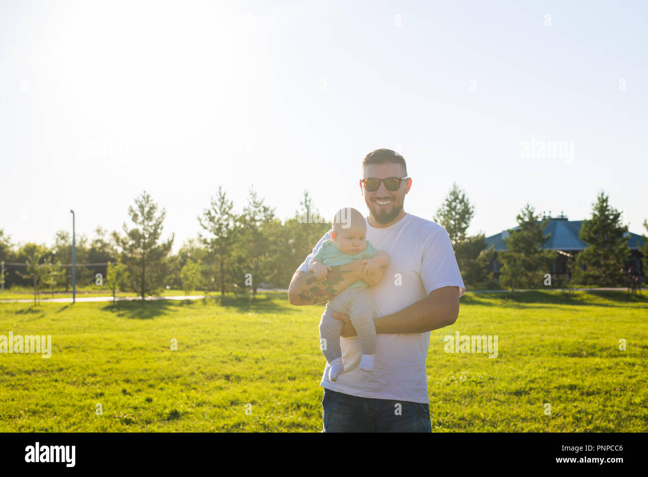 Happy father holding baby son on nature. Concept of happy family ...