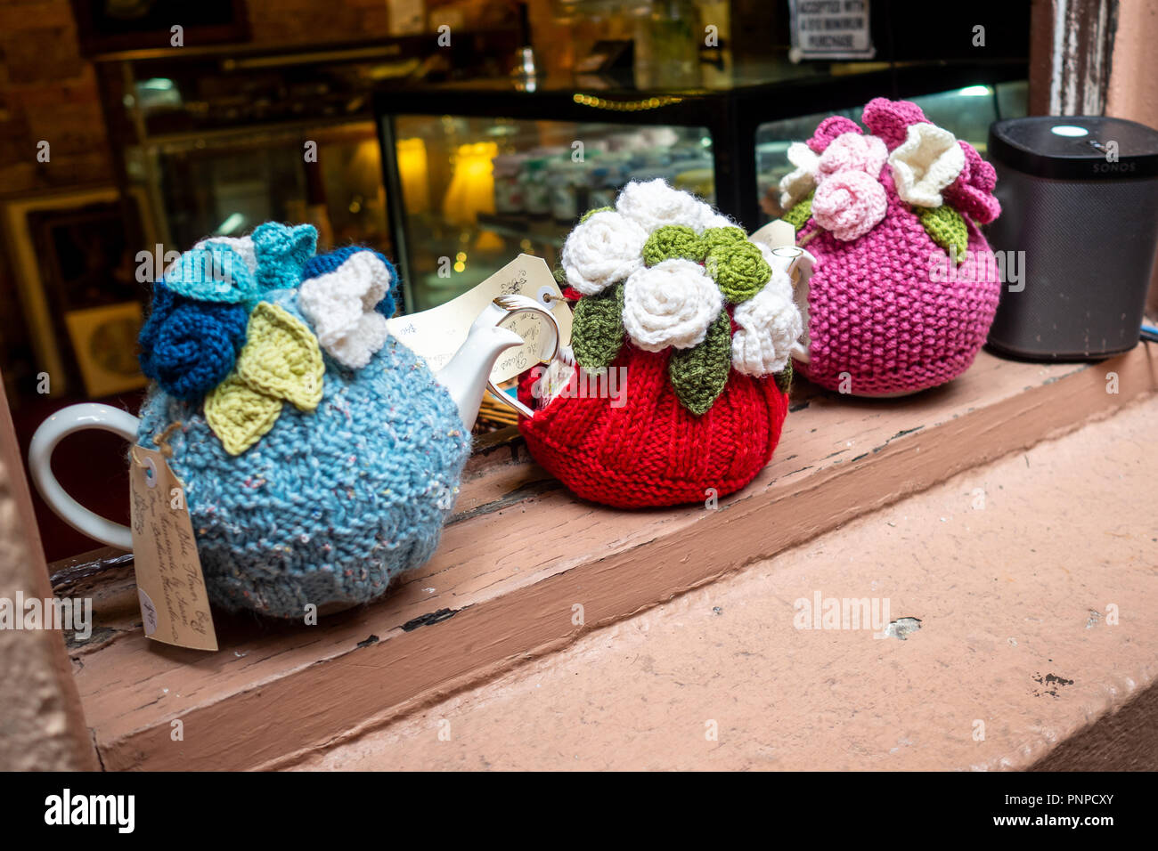Coloured teapots sitting on a window frame Stock Photo - Alamy