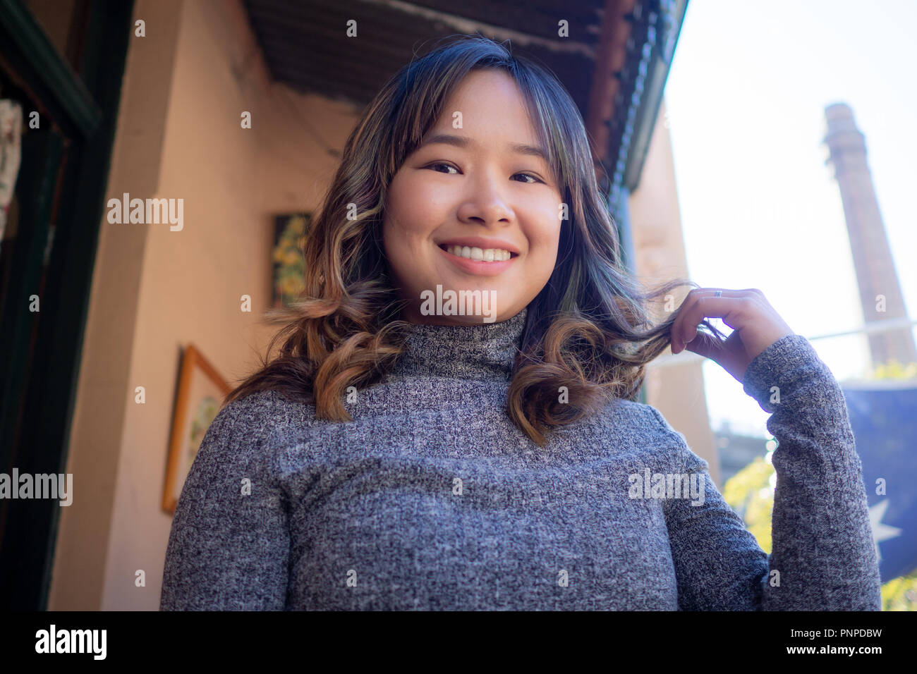 Woman posing cheerfully hi-res stock photography and images - Alamy