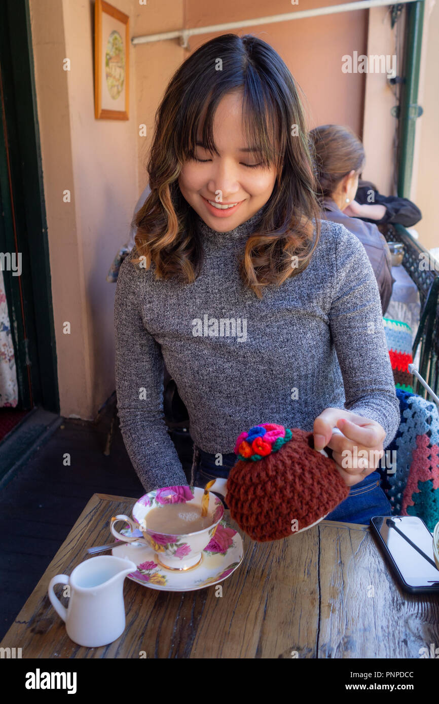 Young woman pouring tea hi-res stock photography and images - Alamy