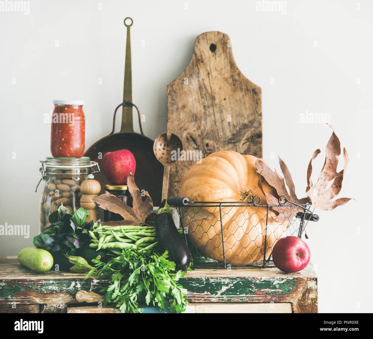 Autumn seasonal food ingredients and kitchen utensils over wooden ...