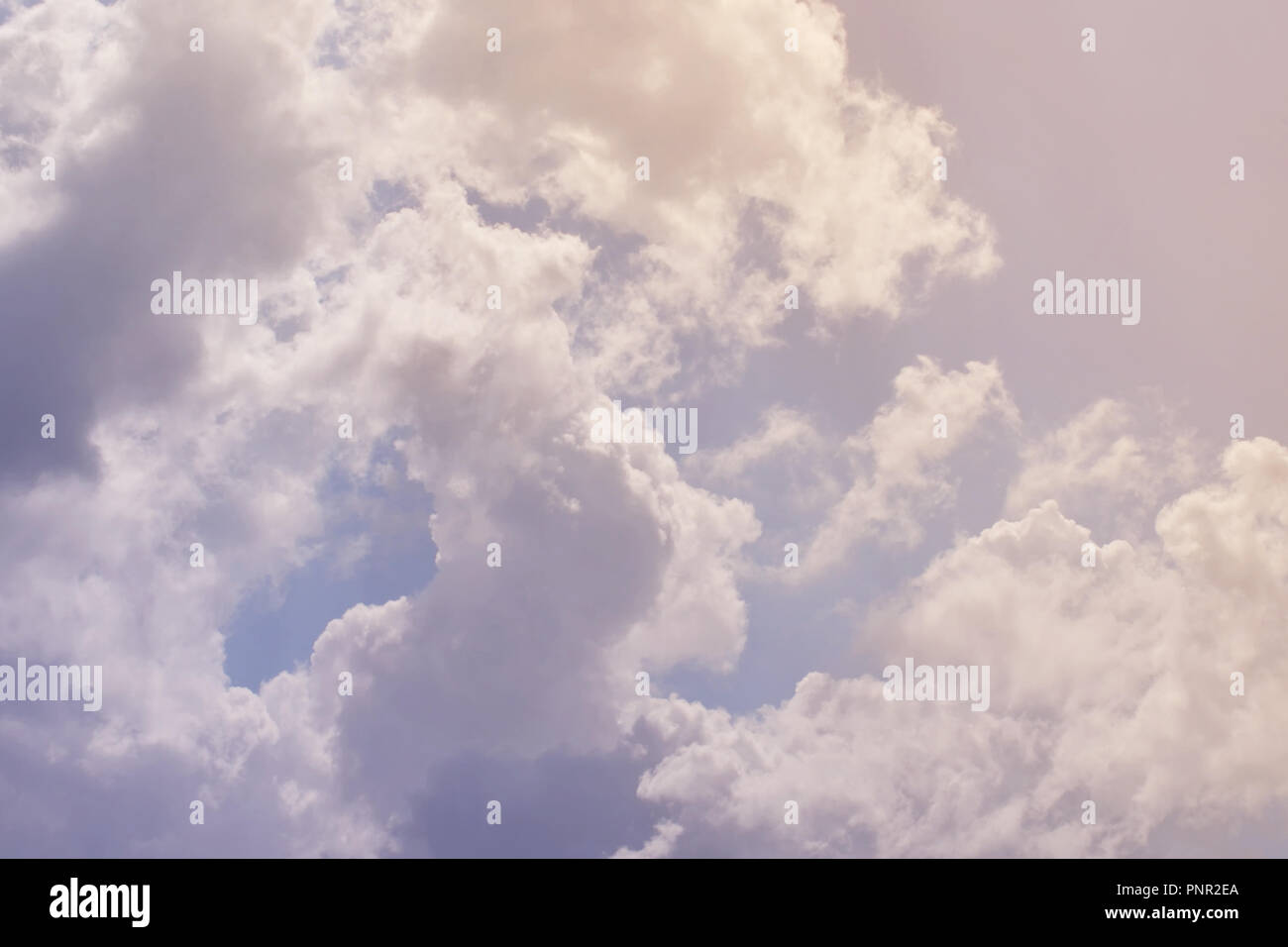 Nature background. Fluffy soft clouds in sky toned Stock Photo - Alamy