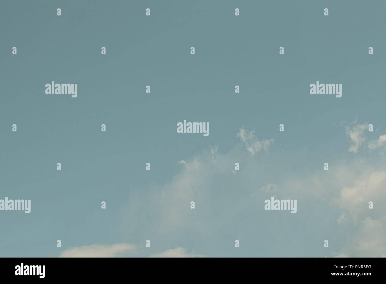Nature background. Fluffy soft clouds in sky toned Stock Photo - Alamy