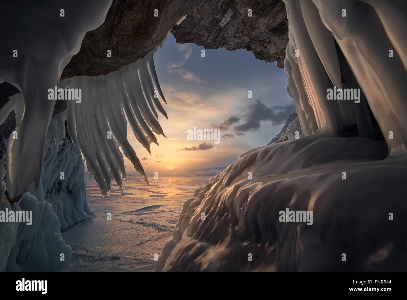 Crystal clear sharp icicles hanging down in frozen cave, lake Baikal ...