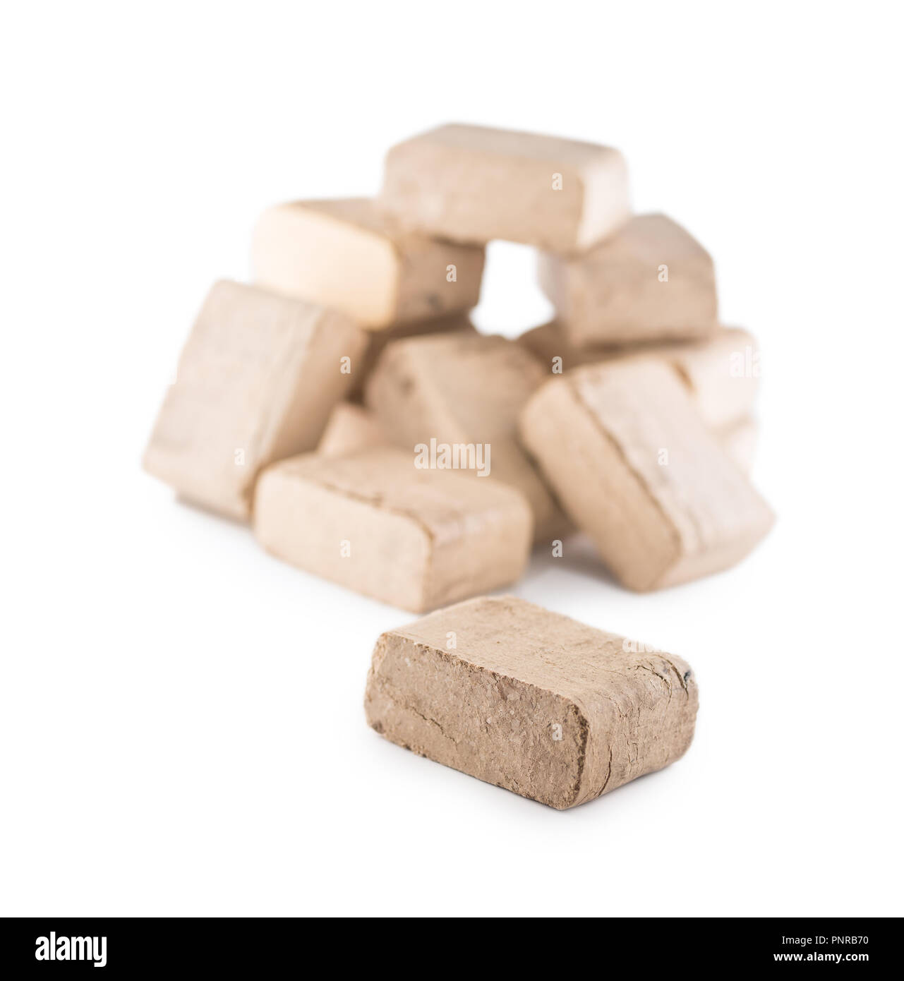 Wooden pressed briquettes from biomass on a white isolated background ...