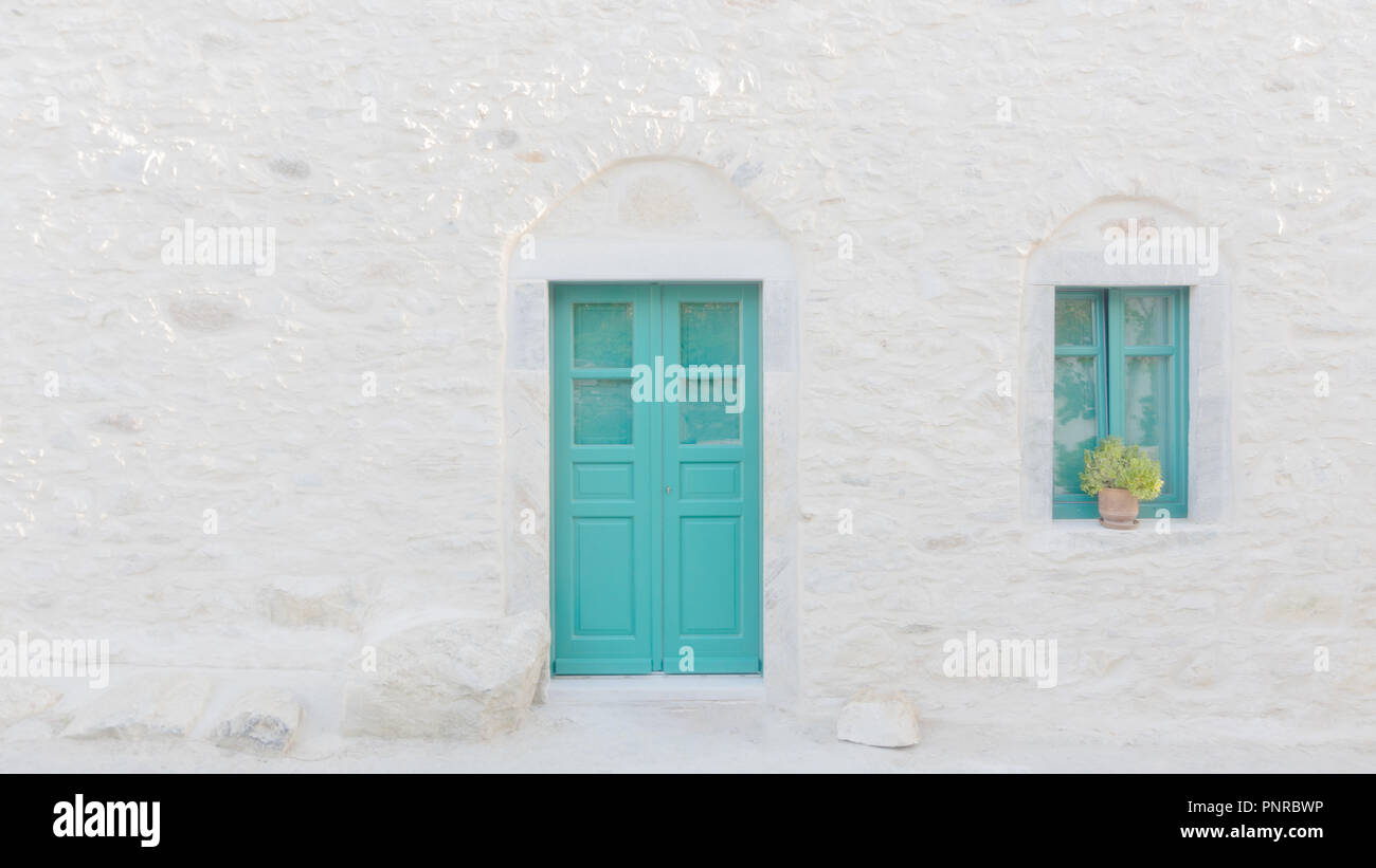 The facade of a genuine Greek house on the Cyclades. Turquoise doors ...