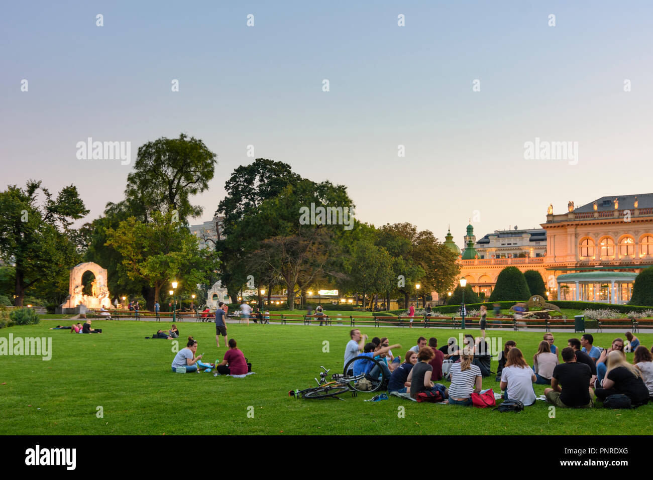 Wien, Vienna: park Stadtpark, palace Kursalon Hübner, people have a picnic at meadow, 01. Old ...