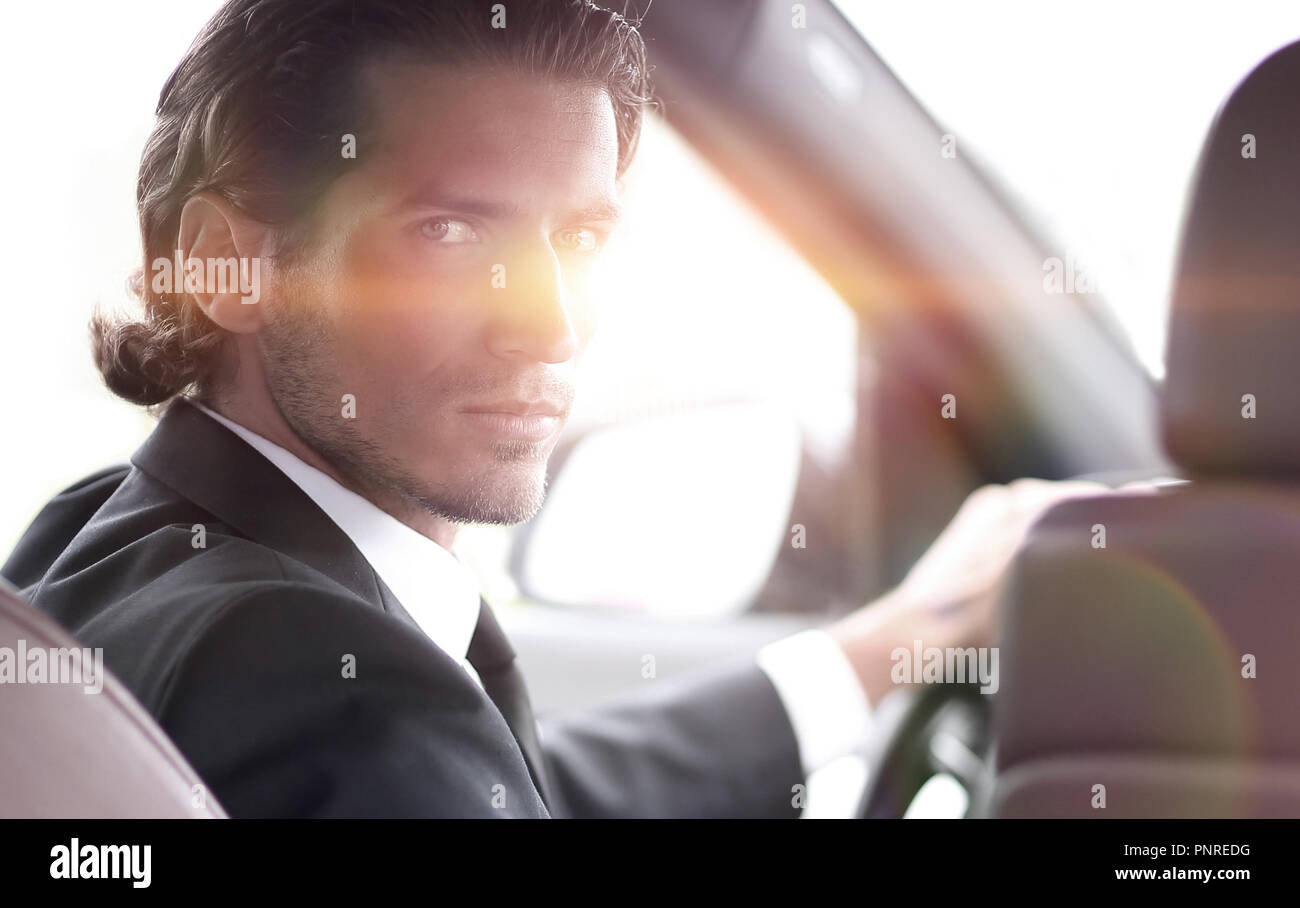 man sitting behind the wheel of a car Stock Photo - Alamy