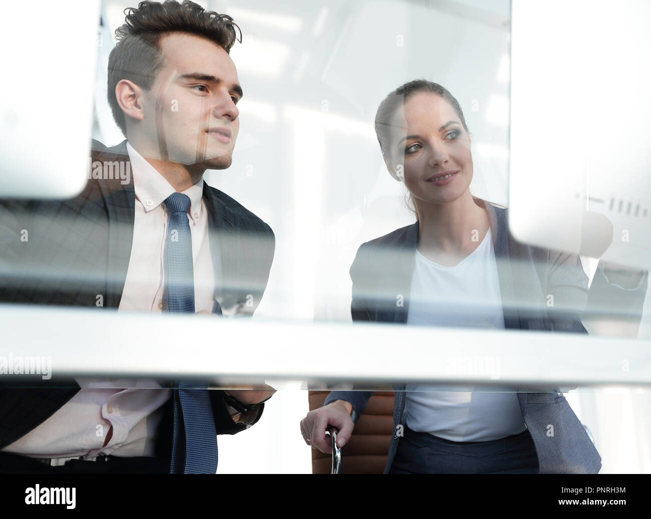 from behind the glass. colleagues at the workplace Stock Photo - Alamy