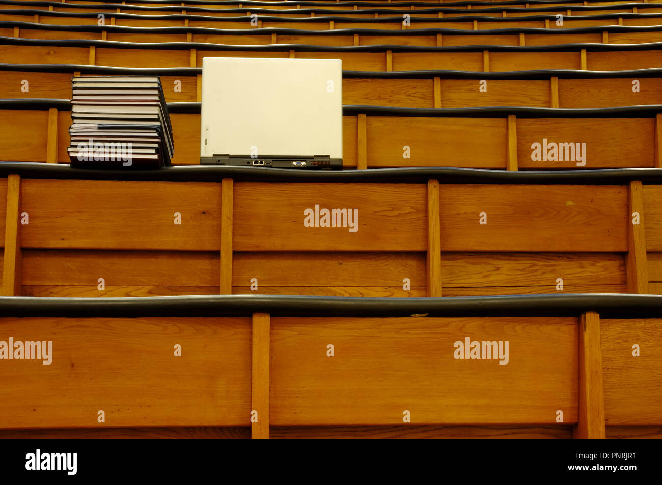 Laptop and books in traditional lecture hall at university Stock Photo ...