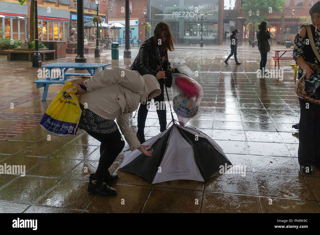 21 September 2018 - People struggle to keep their umbrellas the right ...