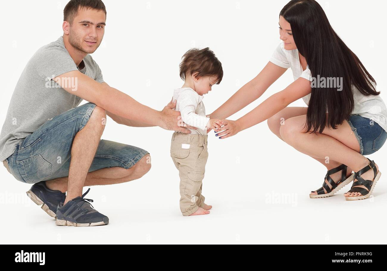 parents watching the baby take the first steps Stock Photo - Alamy