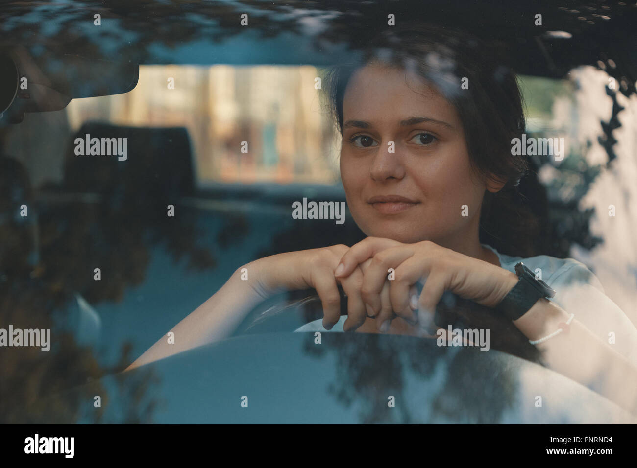 Young business woman driving car - looking through front window. Close ...