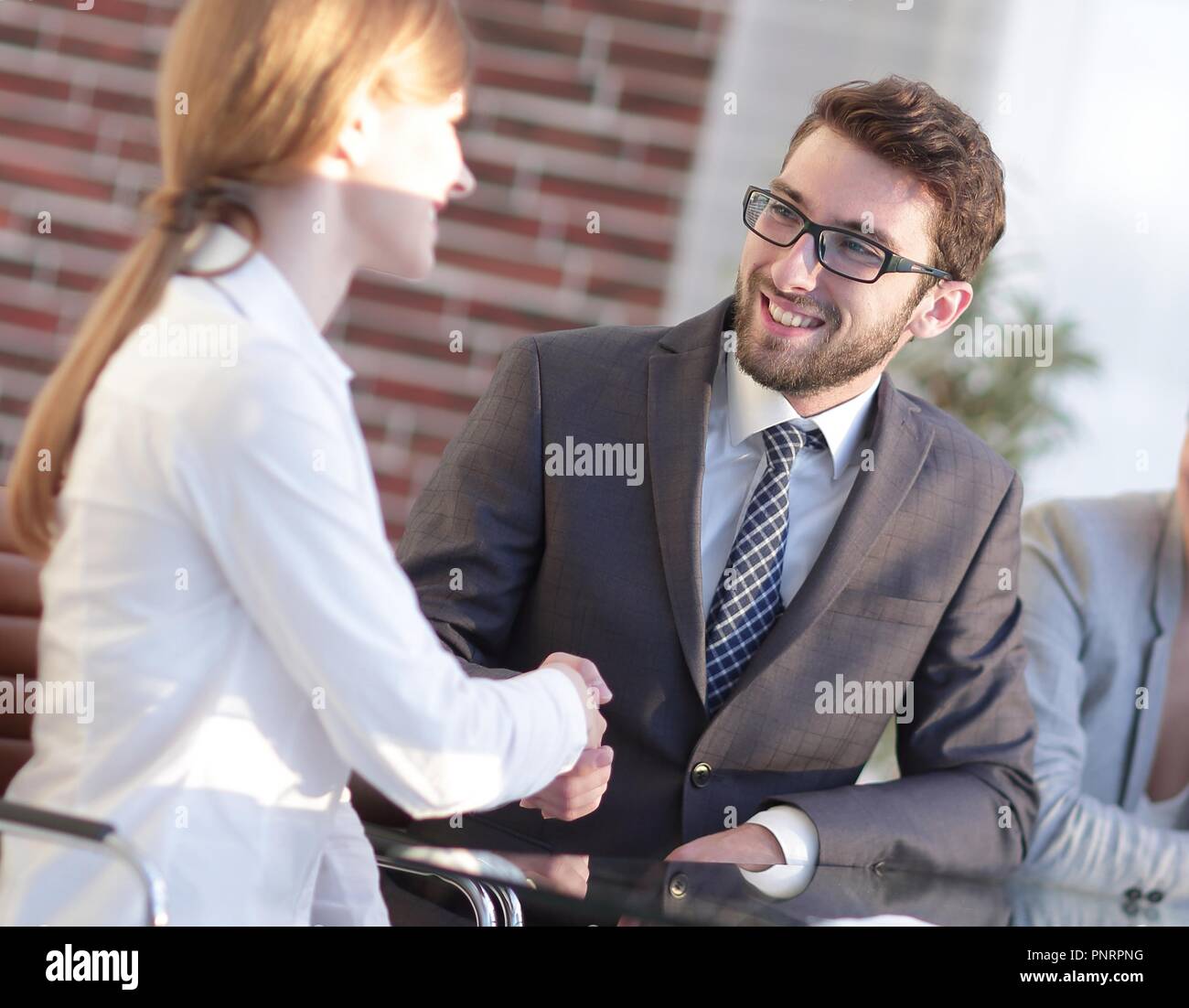 friendly handshake between colleagues in the office Stock Photo - Alamy