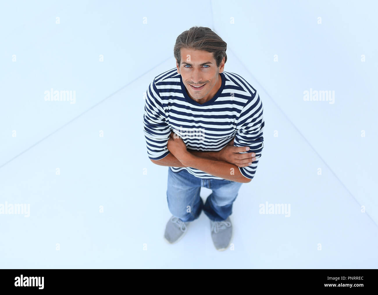 handsome guy standing near the white wall Stock Photo - Alamy