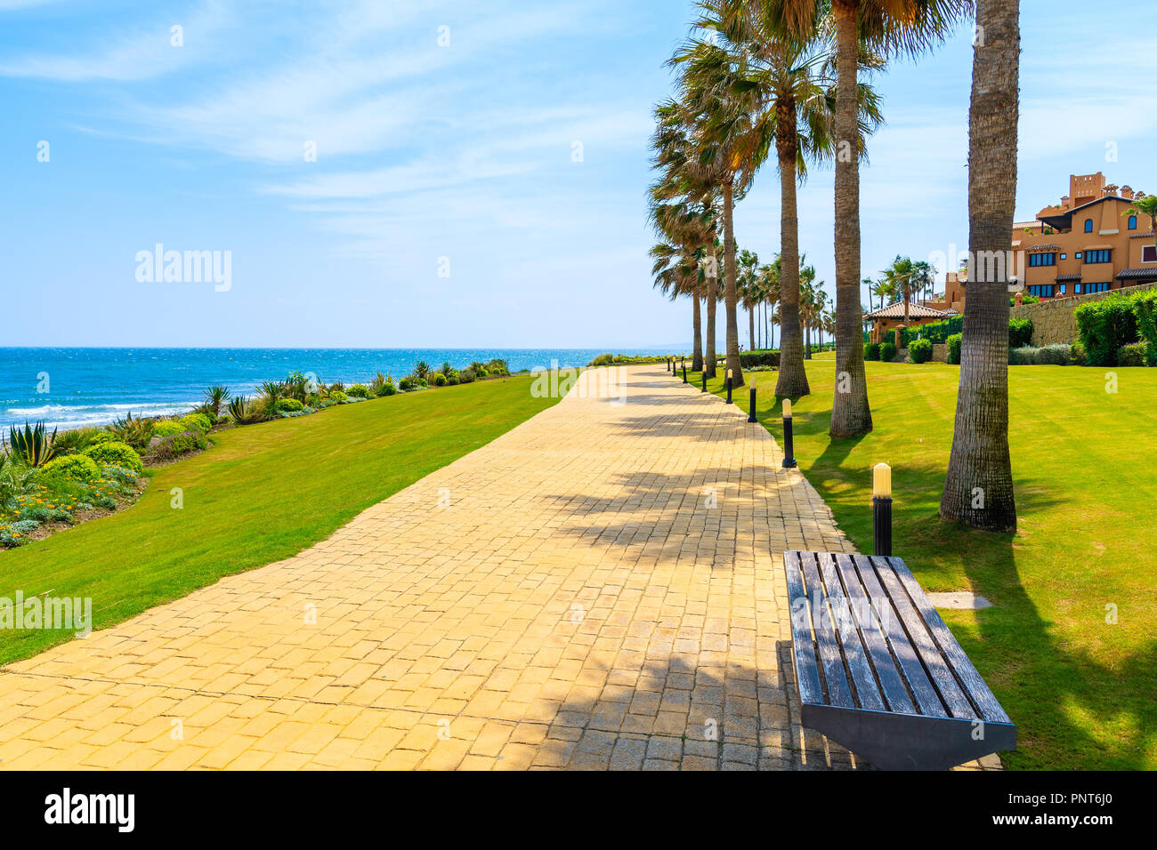 Coastal path with palm trees along sea near Estepona town on Costa del ...
