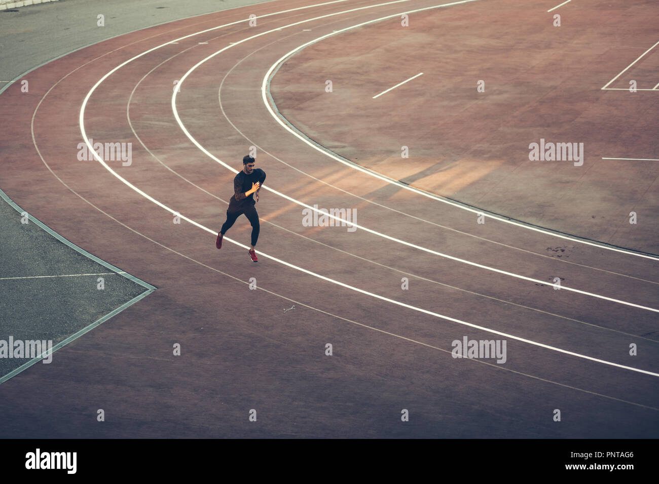 Top view Athlete running on running track. Runner sprinting on red ...
