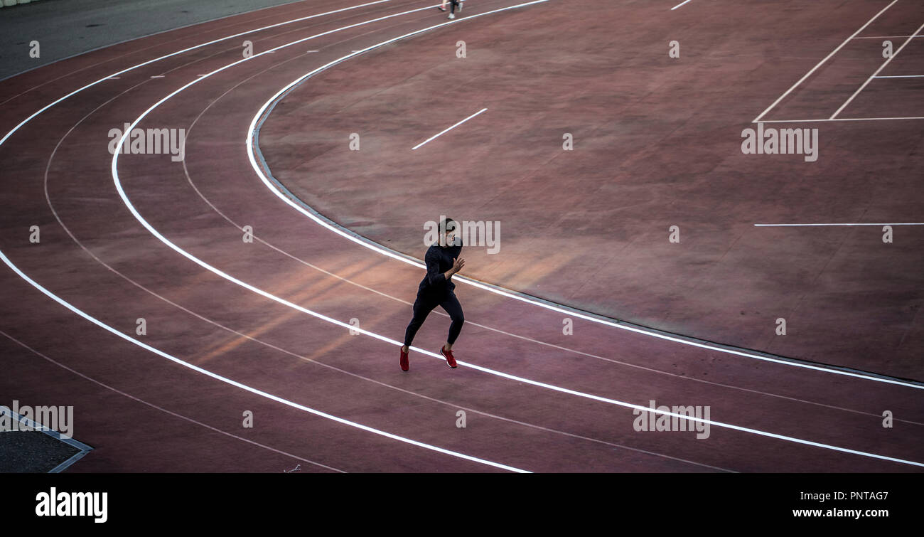 Top view Athlete running on running track. Runner sprinting on red ...