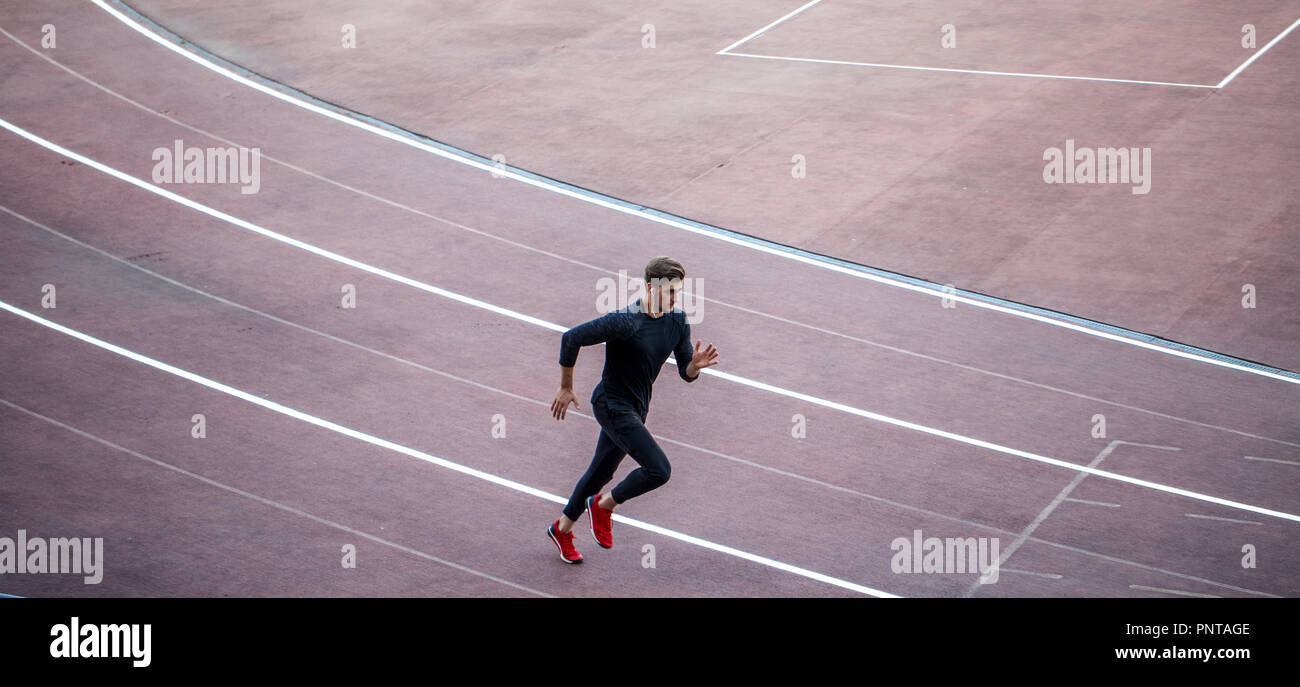 Top view Athlete running on running track. Runner sprinting on red ...