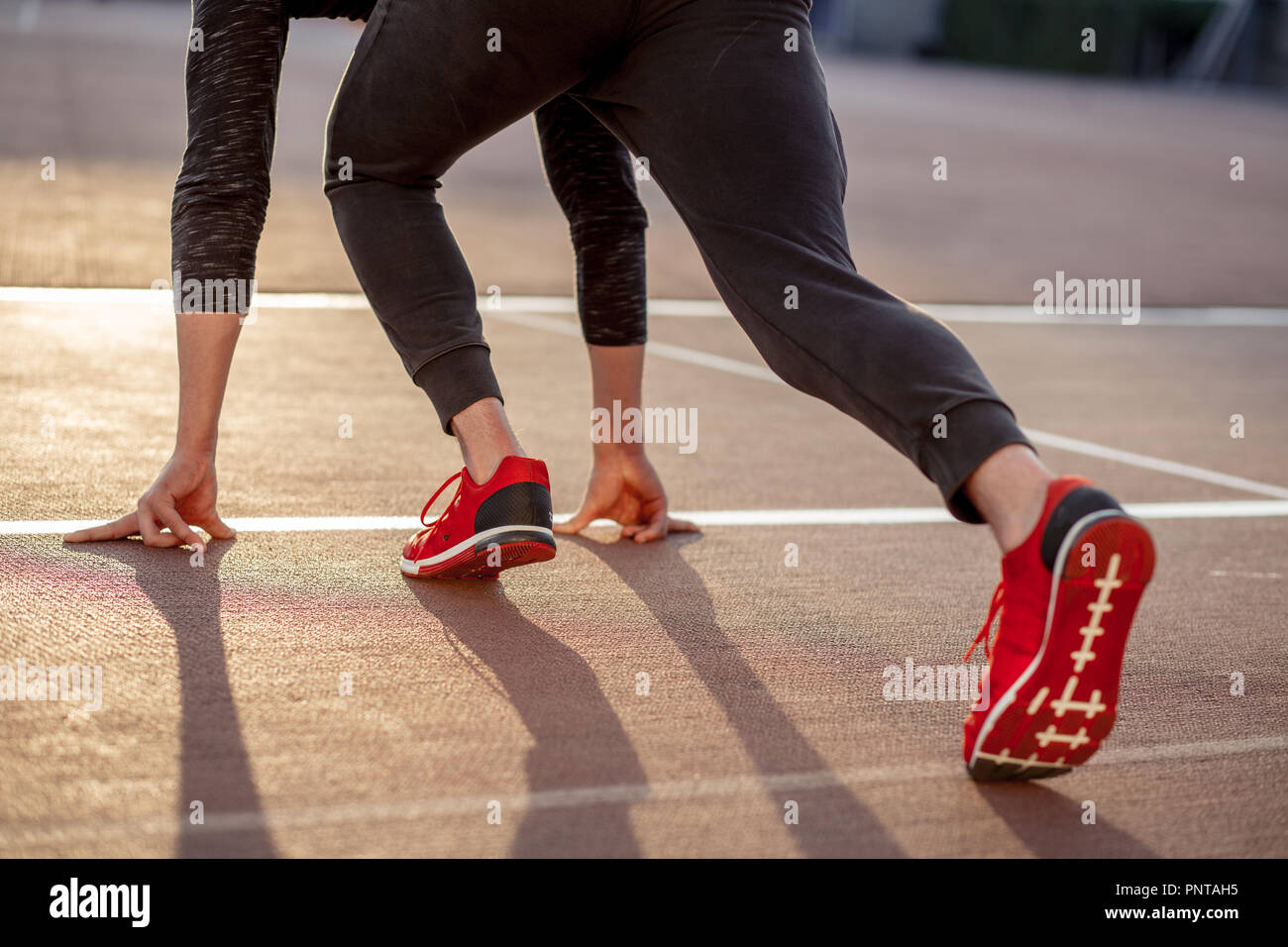 Man at running track in starting position hi-res stock photography and ...
