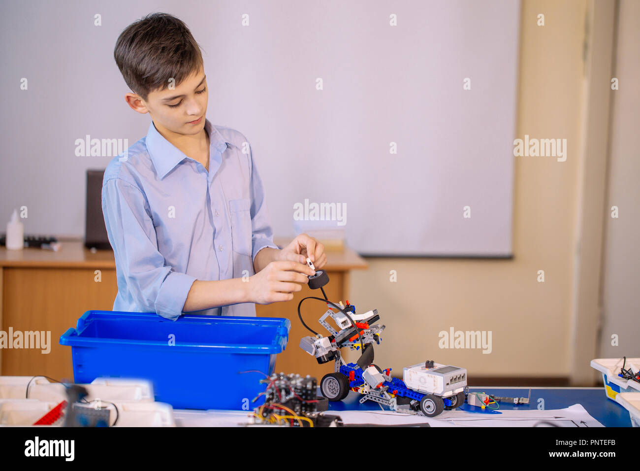 Little boy in robotics school makes robot Stock Photo - Alamy