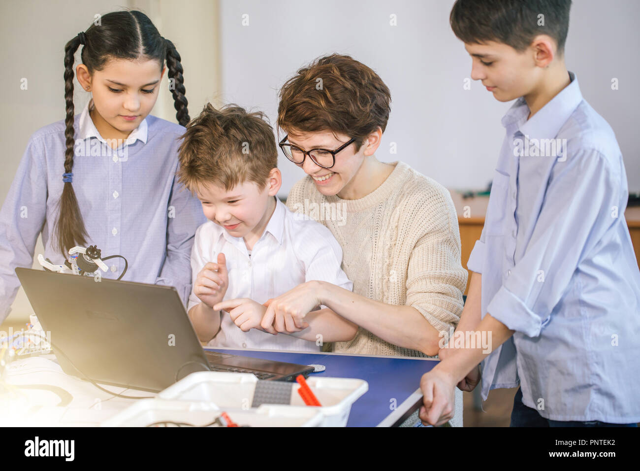 Happy children learn programming using laptops on extracurricular ...