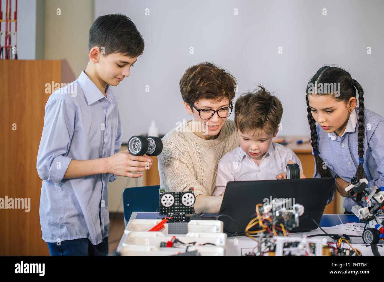Happy children learn programming using laptops on extracurricular ...