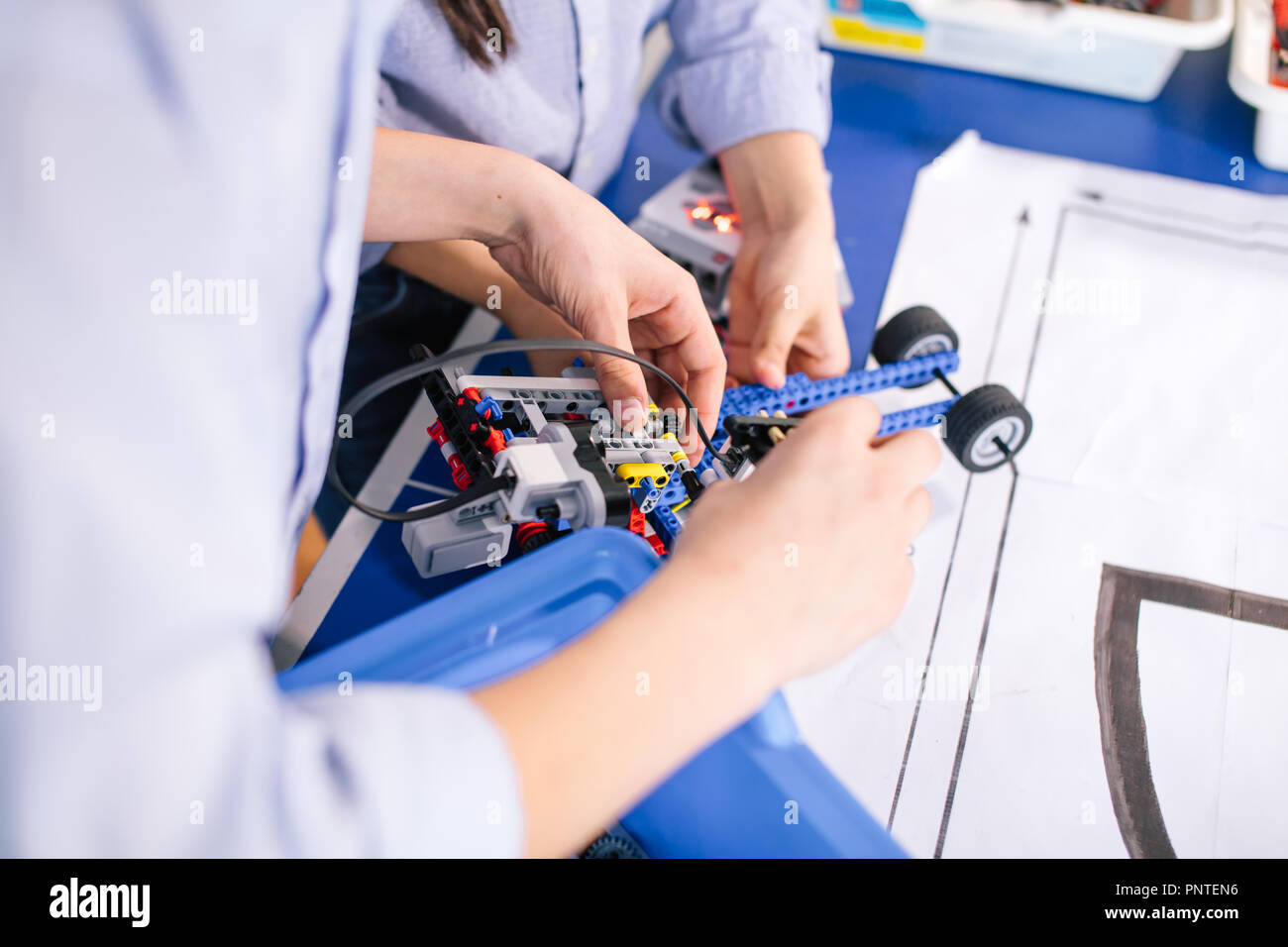 Busy technical team working on toy Stock Photo - Alamy