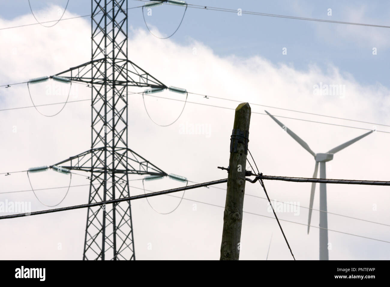 Close up of three different types of energy, old electric post, modern ...