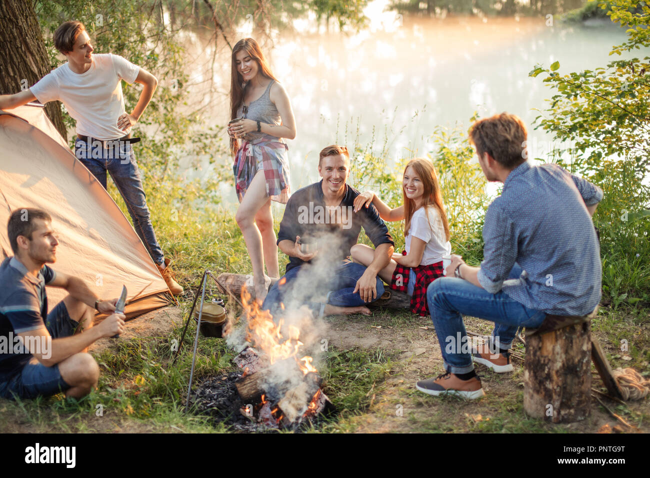 positive adventurous people are waiting for the preparation of dinner ...