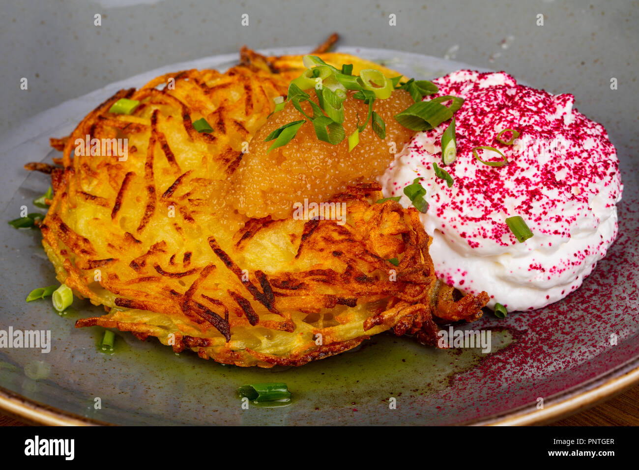Potato pancake - dranik with pike caviar Stock Photo - Alamy