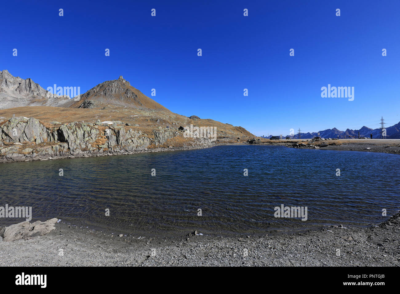 Lake of Nufenen mountain pass street in the alps, Switzerland Stock ...