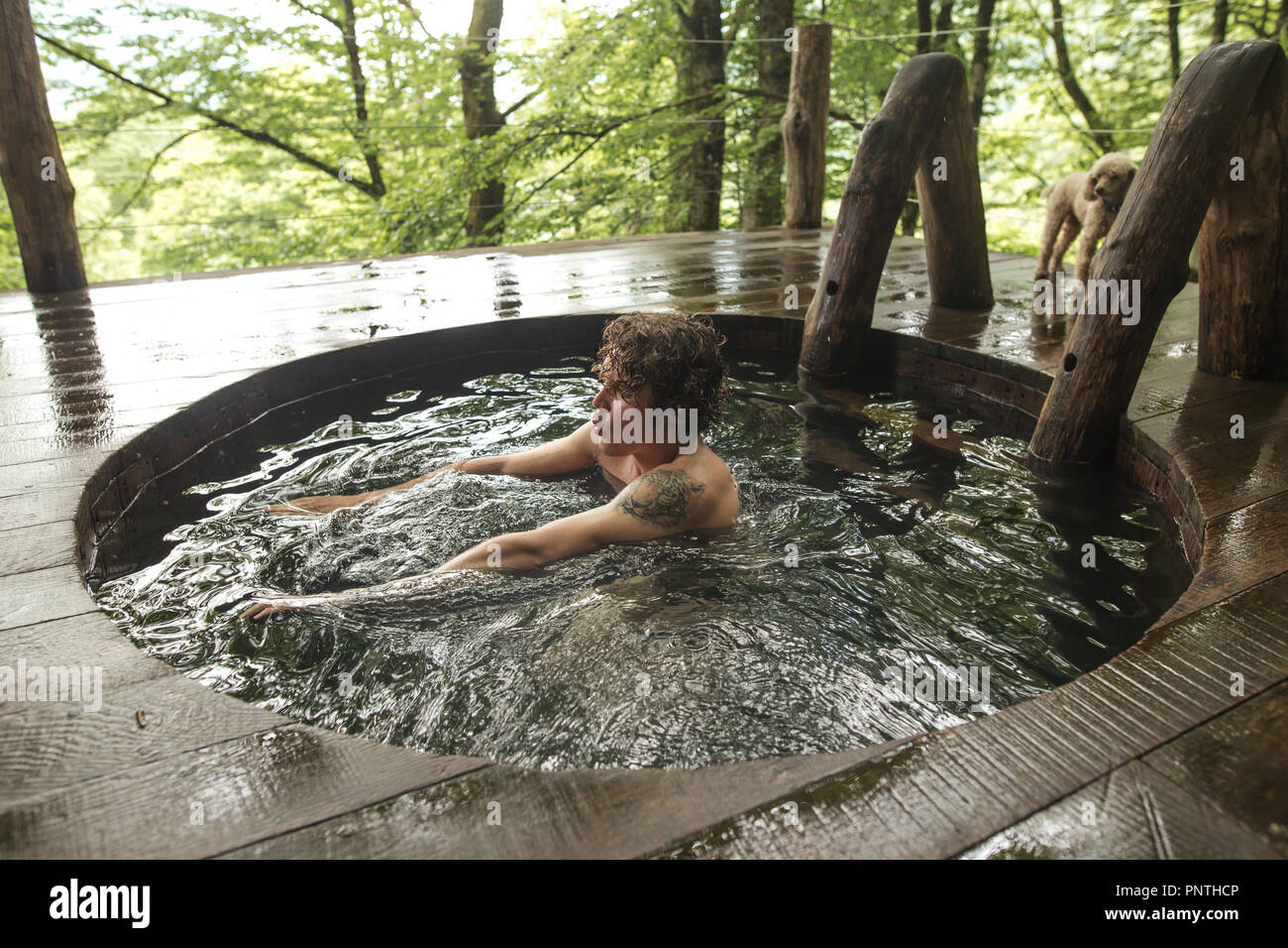 young good looking male is taking a dip in the hot tub Stock Photo - Alamy