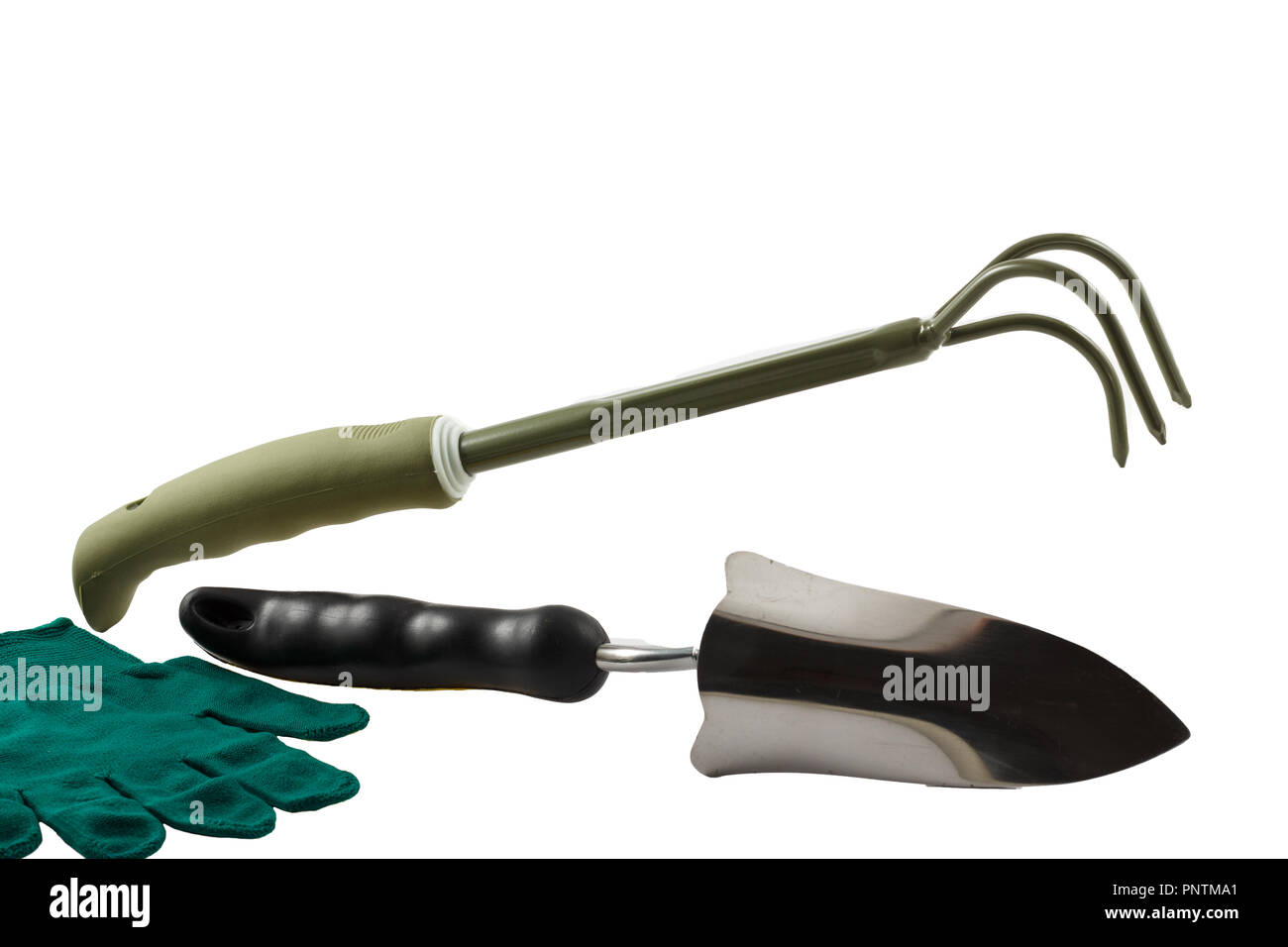 Small hand garden rake, trowel and gloves. They are used for loosening ...