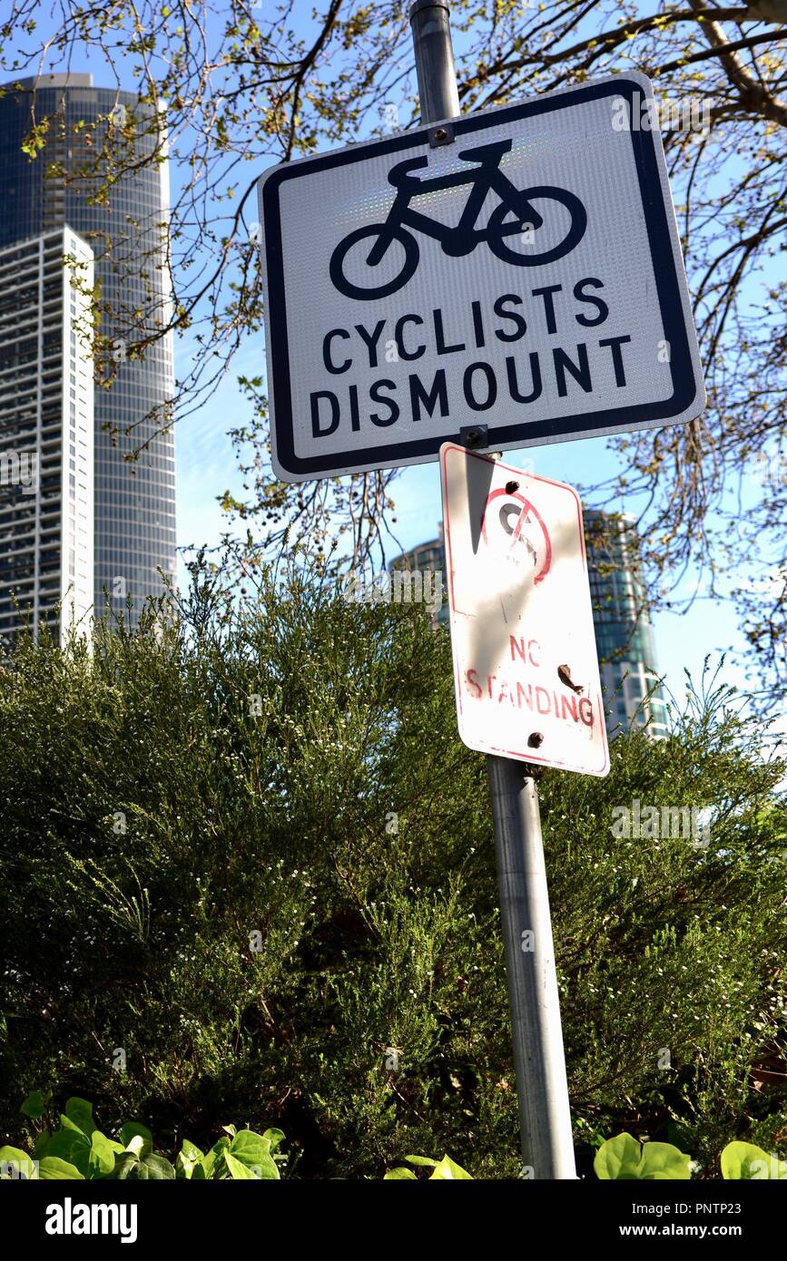 Cyclists dismount sign, Melbourne VIC, Australia Stock Photo - Alamy