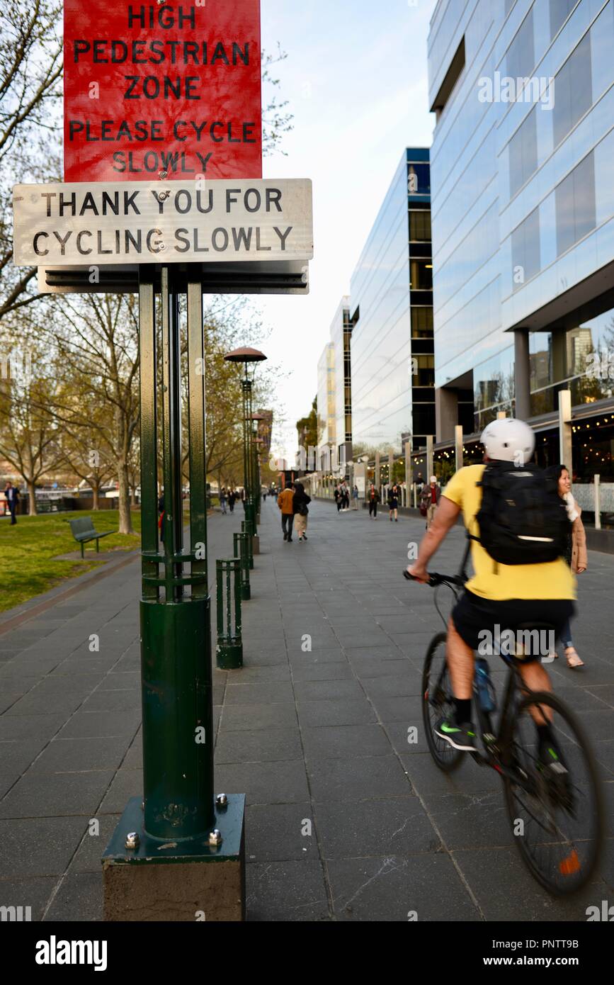 Cyclists riding past a thank you for cycling slowly sign, Melbourne VIC ...