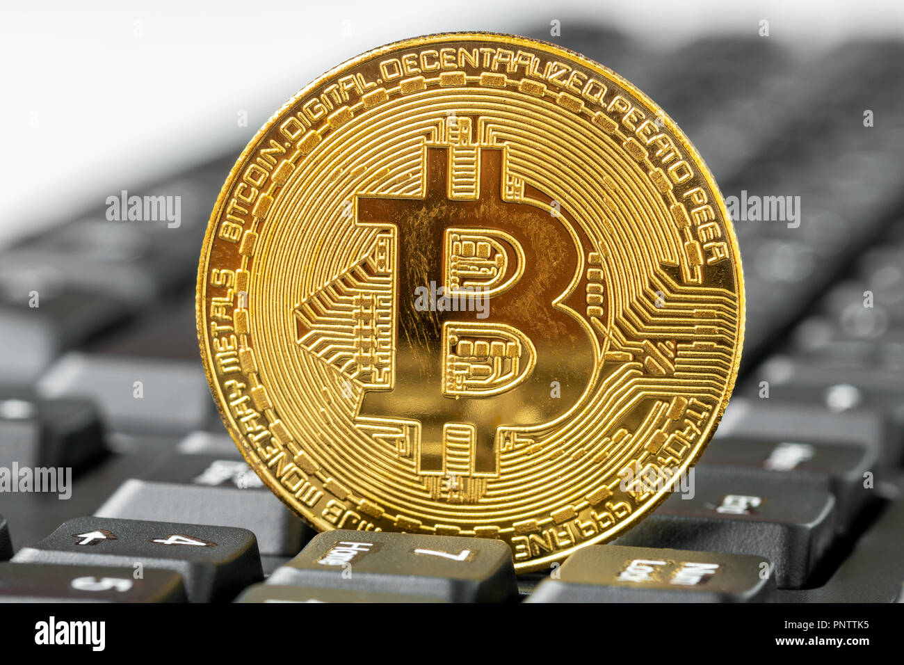 Golden Bitcoin as crypto currency on top of computer keyboard Stock ...