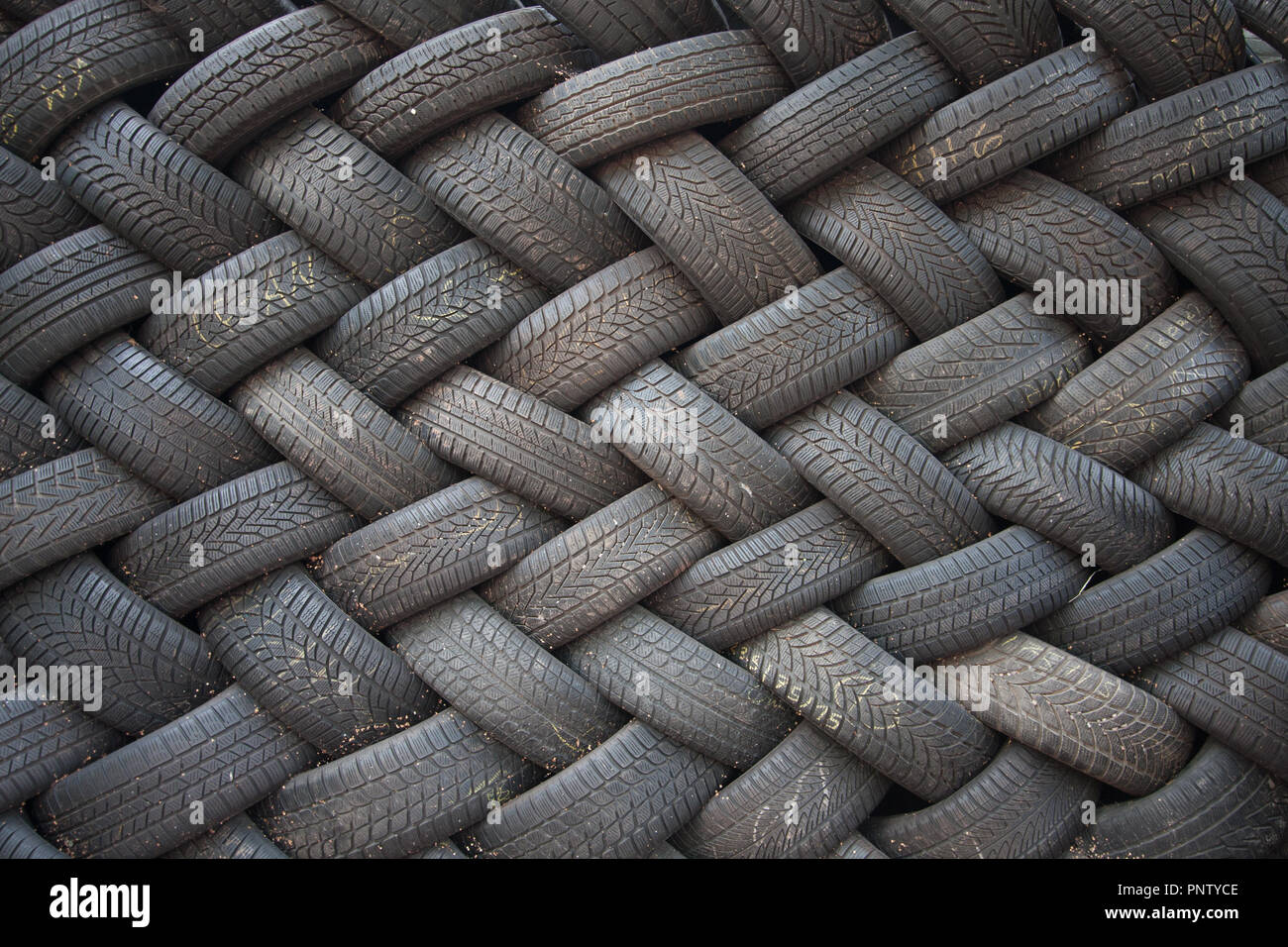 Background, texture of the wall of tires laid at an angle. Black tire ...