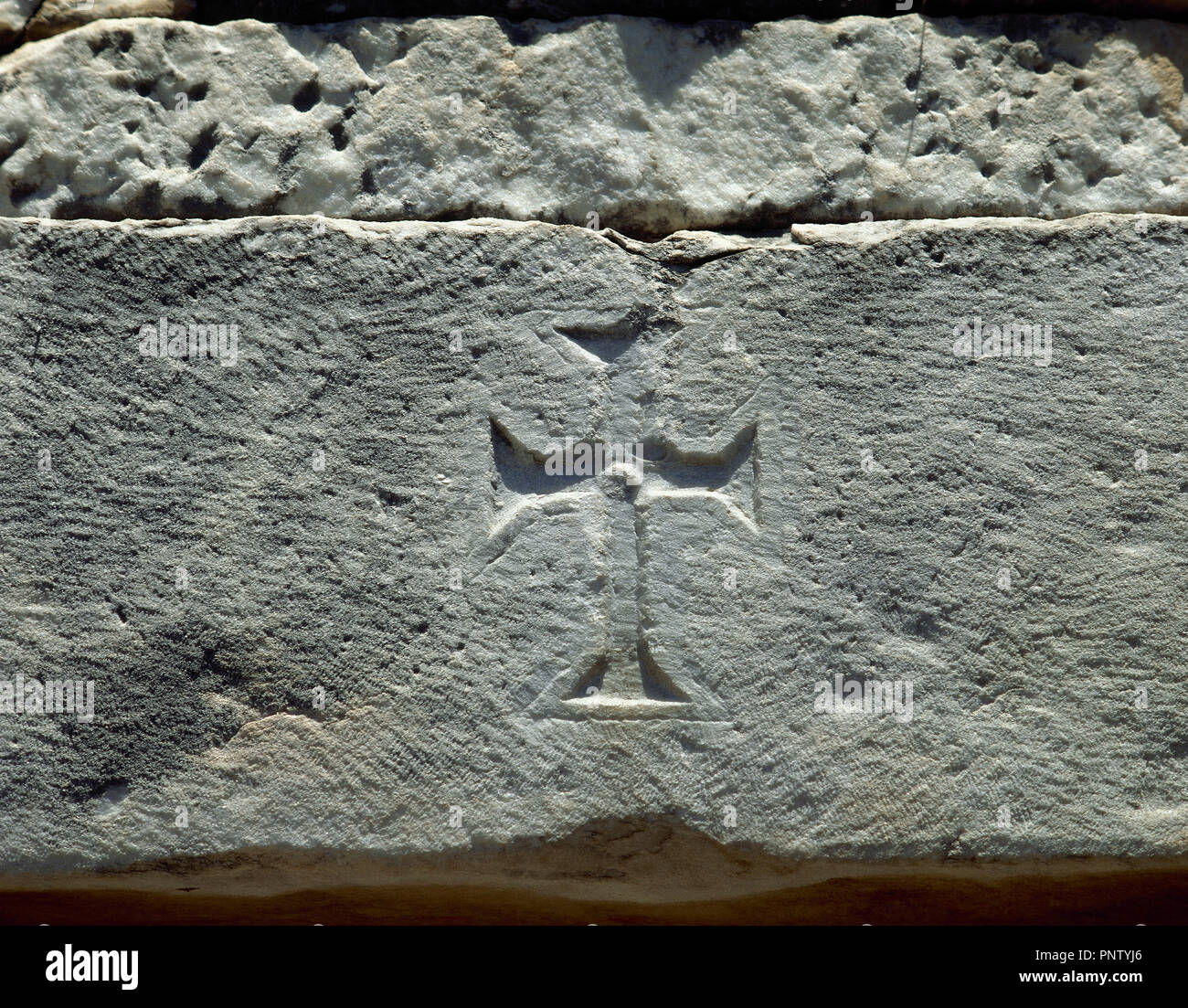 Detail of a cross sculpted in one of the walls of the Roman temple of ...