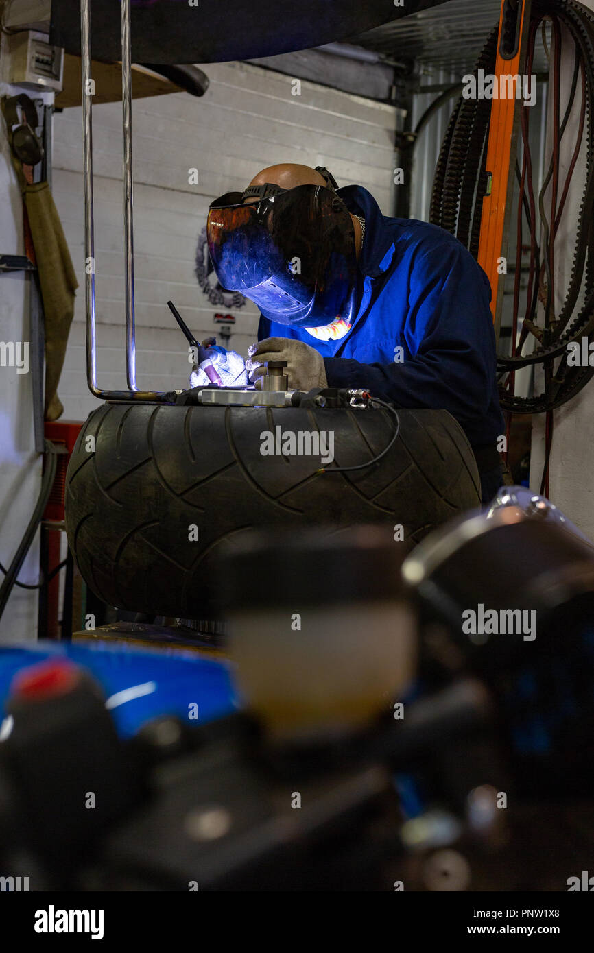 Professional car mechanic working in auto repair service on argon gas ...