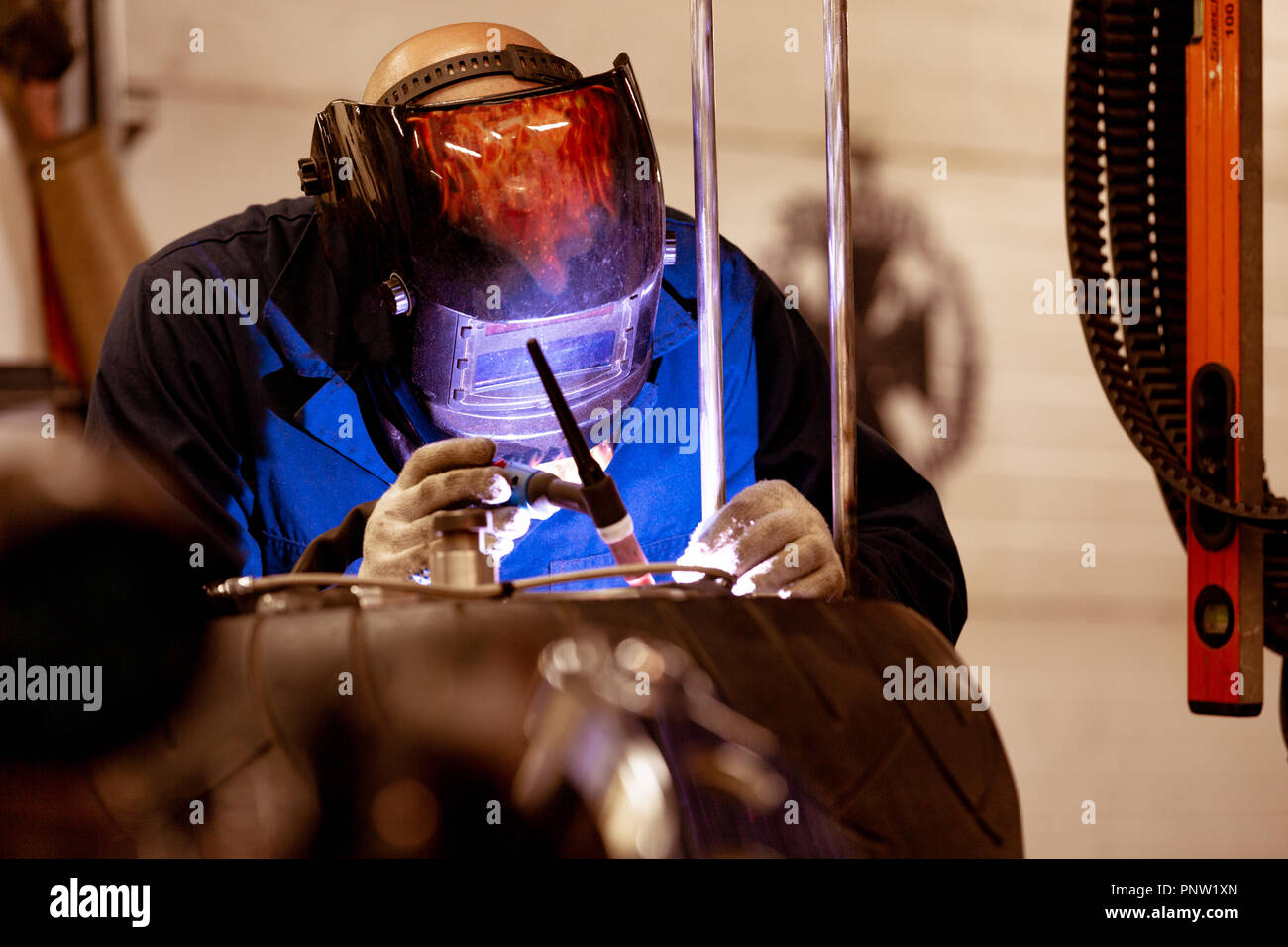 Professional car mechanic working in auto repair service on argon gas ...