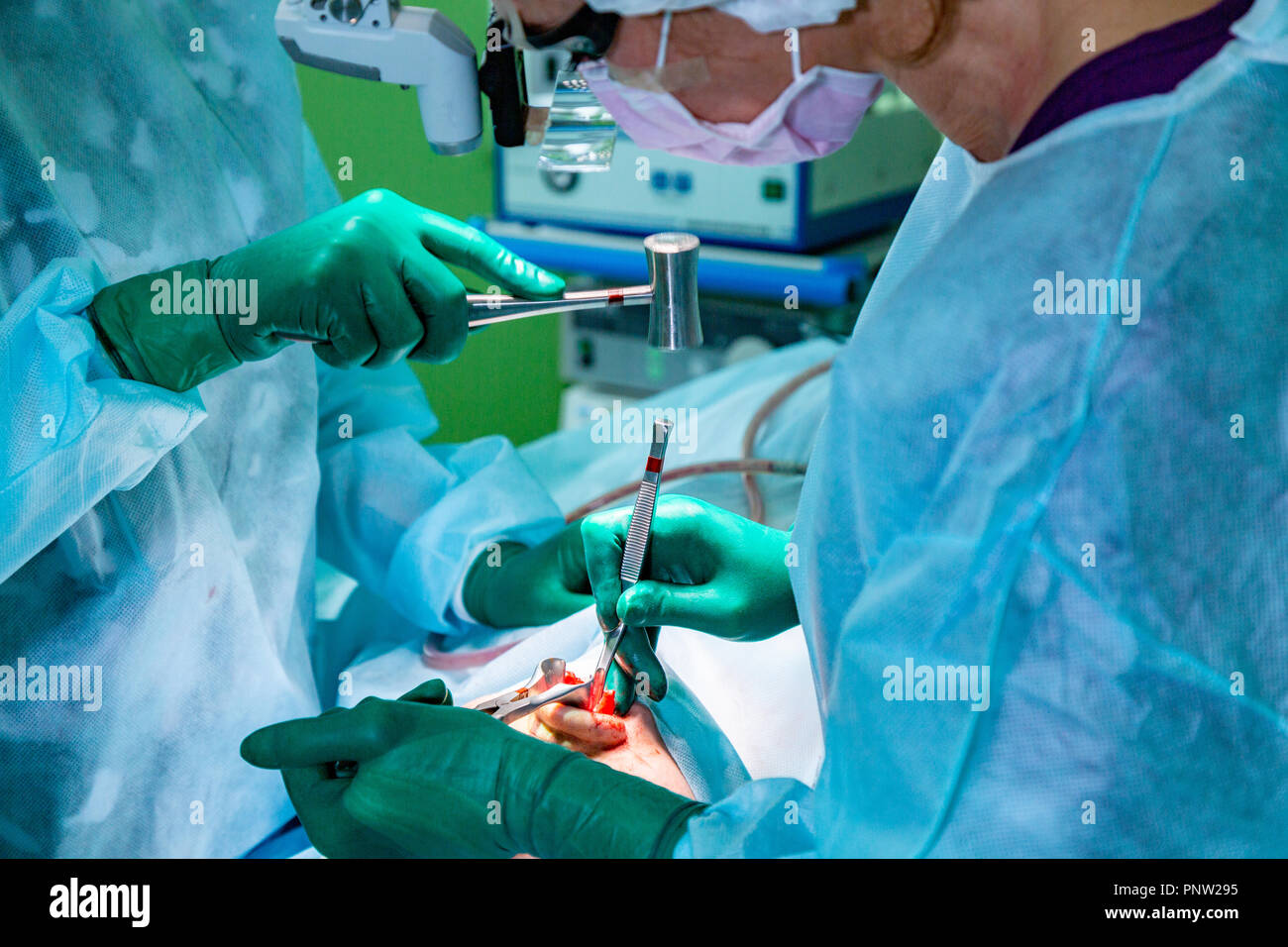 Surgeon and his assistant performing cosmetic surgery on nose in ...
