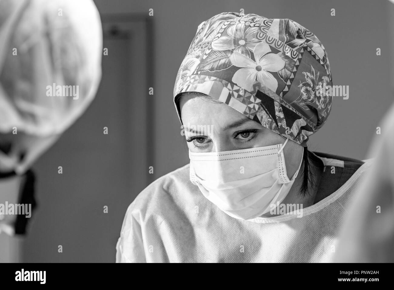 female surgeon doctor wearing protective mask and hat during the ...